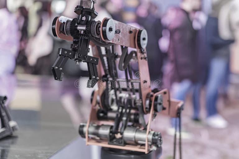 A Metallic Robotic Arm, with Multiple Joints and Extending from a Base ...