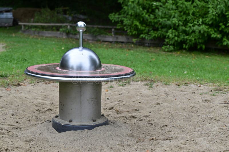Metallic Spinning Top in Playground Stock Photo - Image of city, person ...