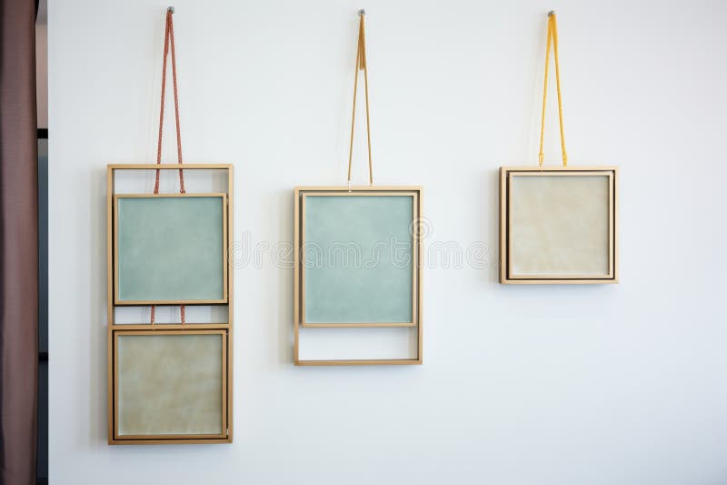Metallic Square Frames Hanging on a Neutral Wall Stock Photo - Image of ...