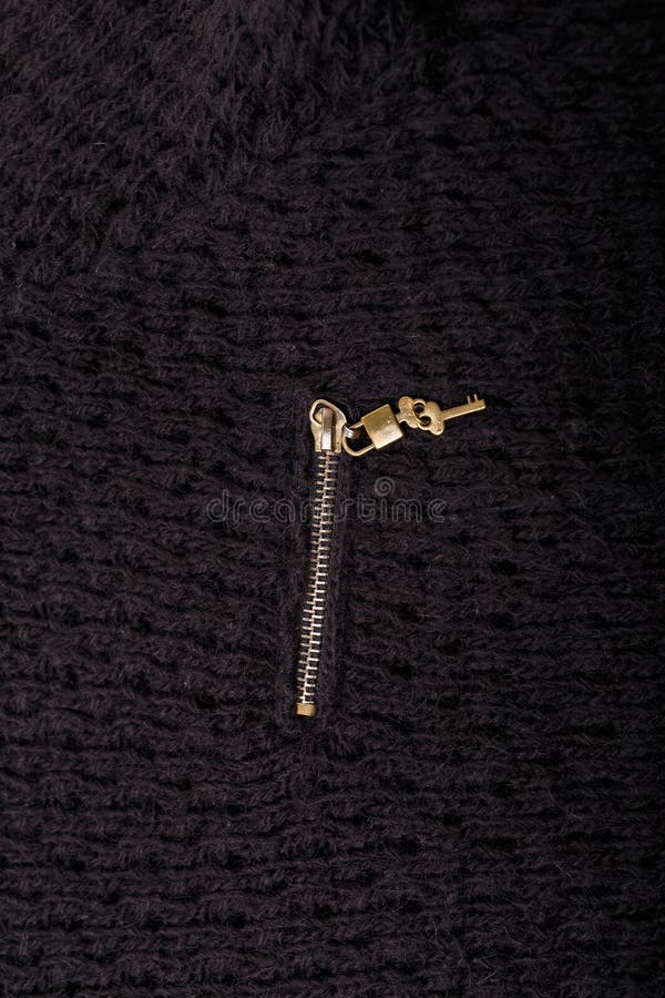 Metallic Zipper, Lock and Key on Knitted Black Cloth Background Stock ...
