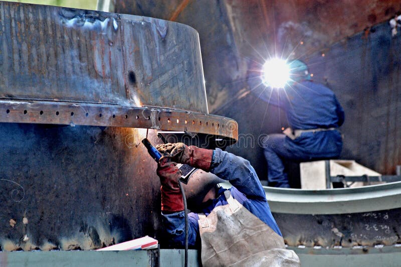 Metalwork Construction of Large Tubes with Workers Working Welding ...