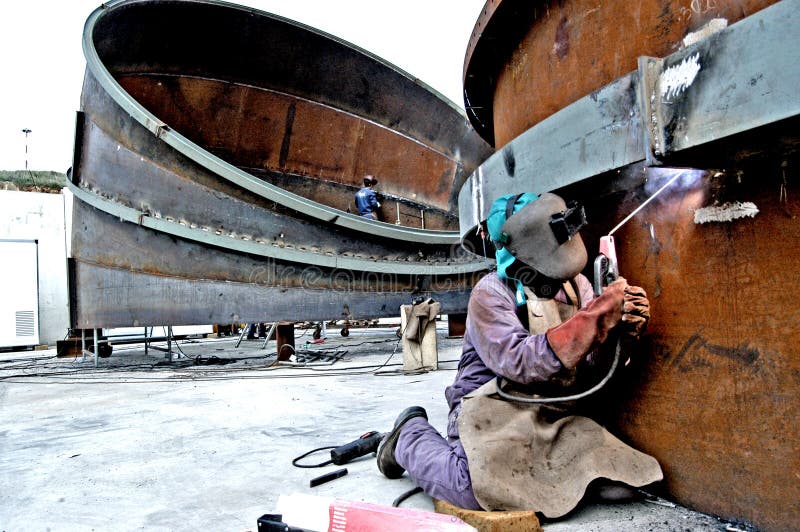Metalwork Construction of Large Tubes with Workers Working Welding ...