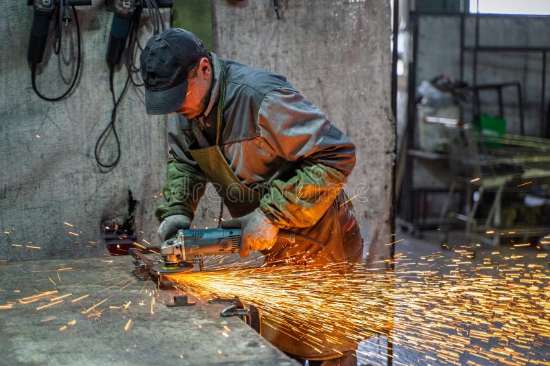 Metalworker Grinding Steel in Industrial Workshop with Bright Flying ...