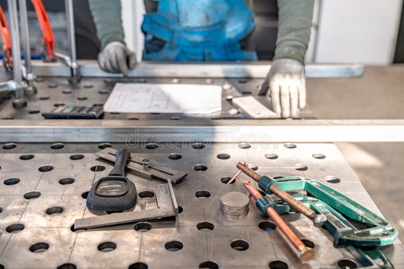 Metalworker Using Welding Table with Tools and Blueprint Stock Photo ...
