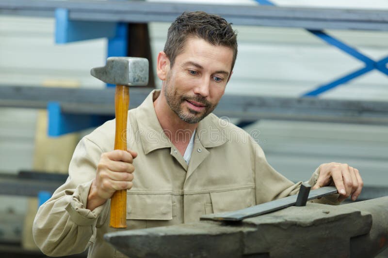 Metalworker Works Metal with Hammer on Anvil Stock Photo - Image of ...