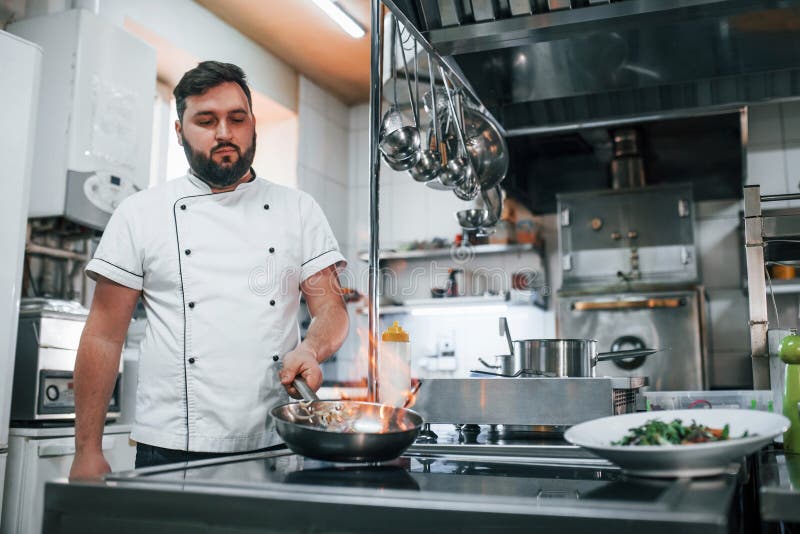 Method of Cooking by Igniting Meal. Professional Chef Preparing Food in ...