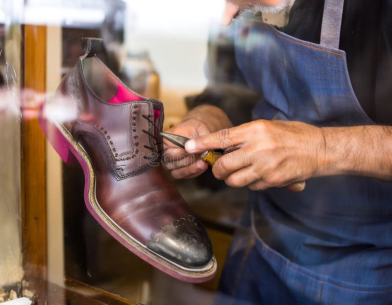 Meticulous Artisan Repairing a Leather Shoe with Precision Tools in a ...