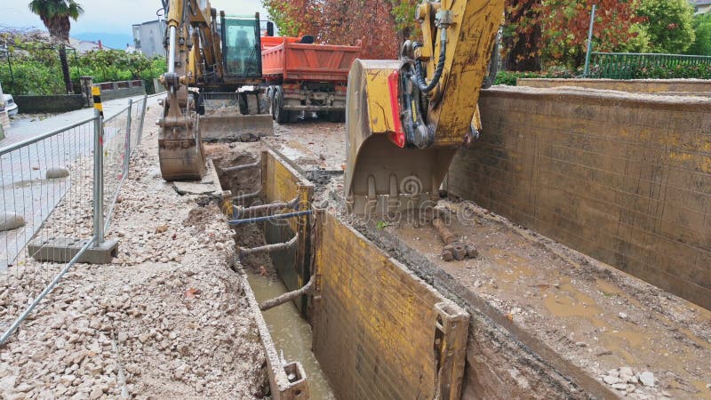 Construction Site with Excavator Digging Deep Trench for Infrastructure ...