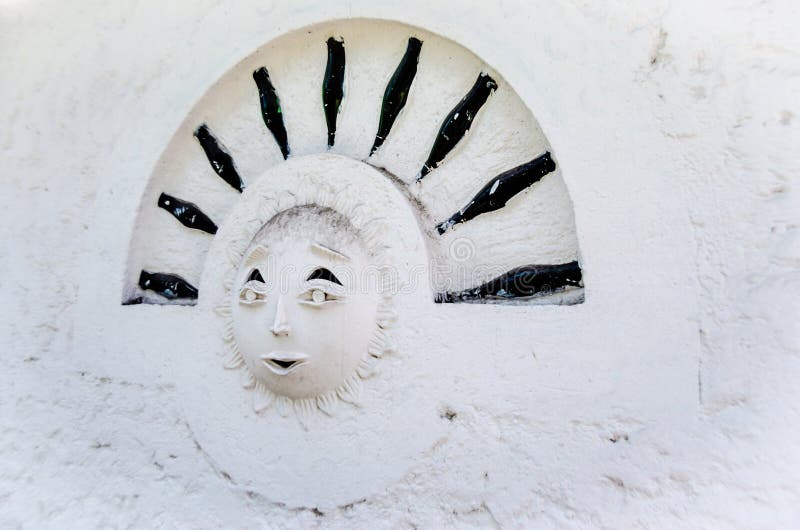 Mexican Bottle Window with Sun Face in a Plaster Exterior Wall. Stock ...
