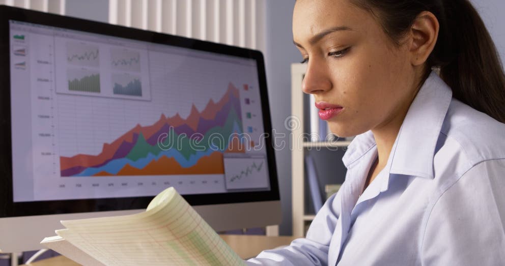 Mexican Businesswoman Writing Notes by Computer Stock Image - Image of ...