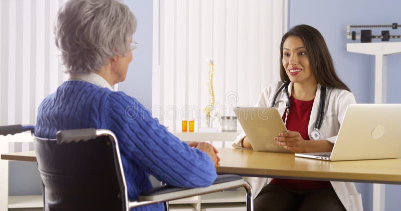 Mexican Doctor Talking with Elderly Patient Stock Photo - Image of ...