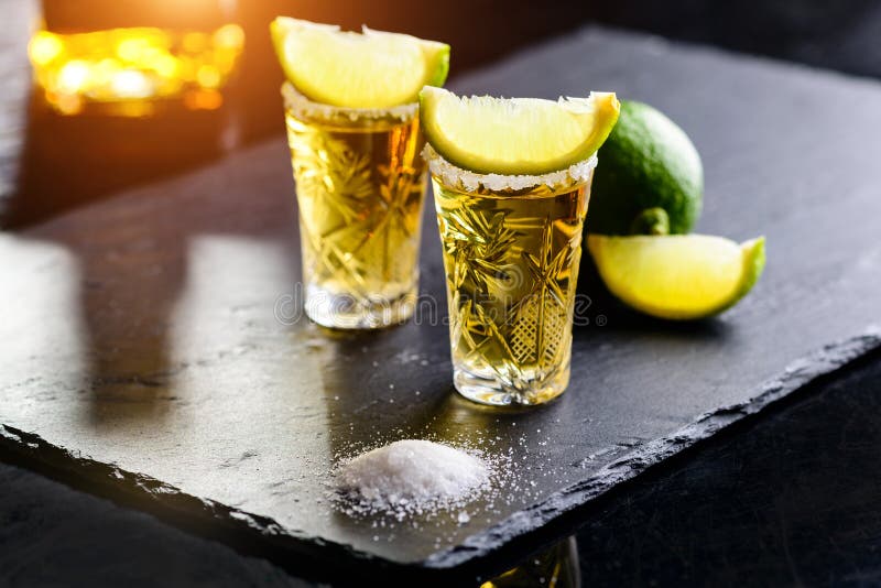 Gold Mexican Tequila With Lime And Salt On Dark Table, Toned Image ...
