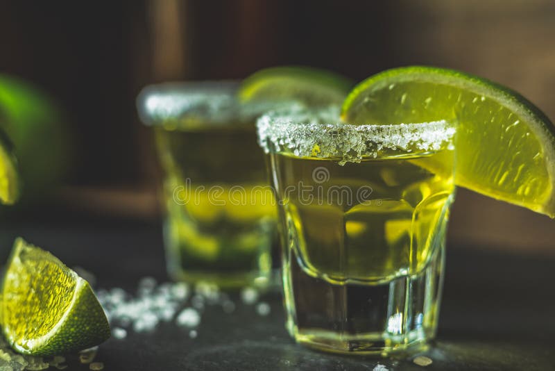 Mexican Gold Tequila Shot with Lime and Salt on Black Stone Table ...