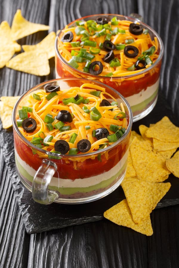 Mexican Seven Layer Dip Salad Served with Chips Close-up. Vertical ...