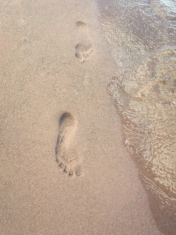 Two footprints in the sand stock image. Image of human - 34558679
