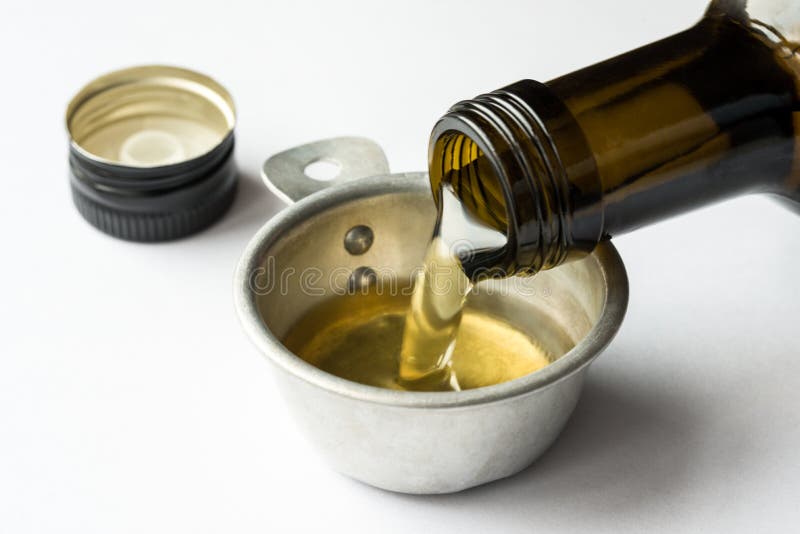 Pouring Oil To Measuring Cup To Add it To Fuel Tank Stock Photo - Image ...