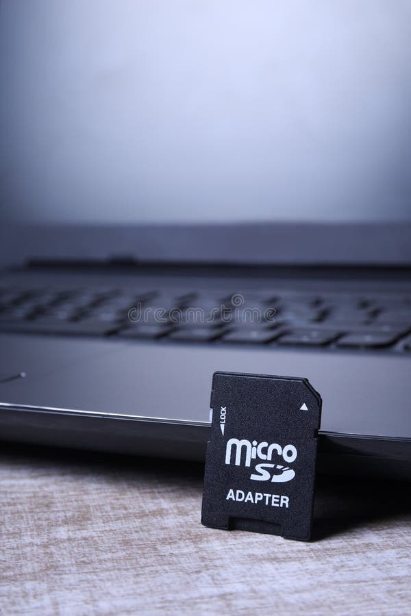 Micro SD Memory Card Adapter on Laptop Background on the Wooden Table ...