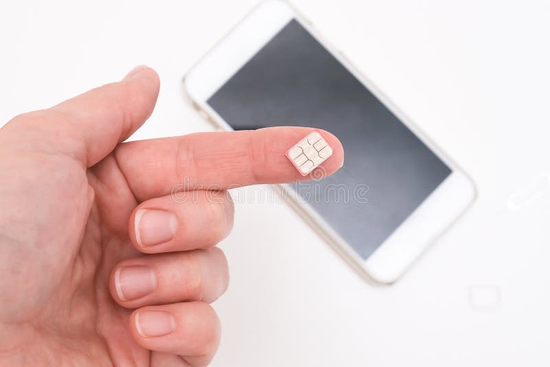 Micro Sim Card for Mobile Communication on a Finger Close Up, Wireless ...