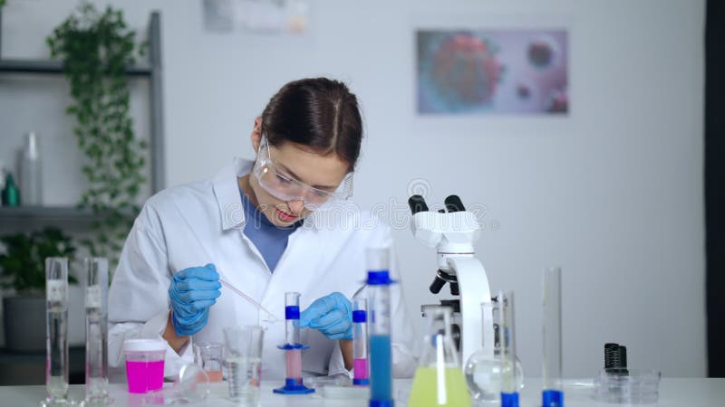 Microbiological Investigation in Laboratory, Woman Employee is Viewing ...