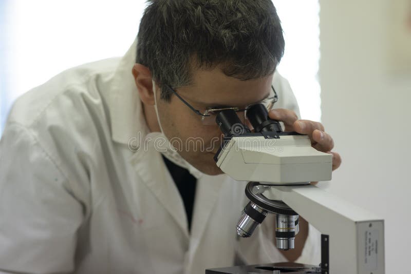 Microbiologist at Work Using a Microscope Stock Photo - Image of ...