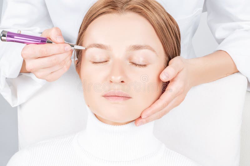 Microblading Eyebrows. Attractive Woman Getting Facial Care and ...
