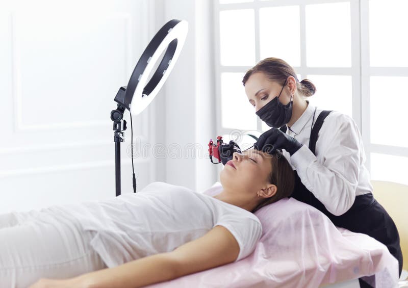 Microblading Eyebrows Work Flow in a Beauty Salon. Woman Having Her Eye ...