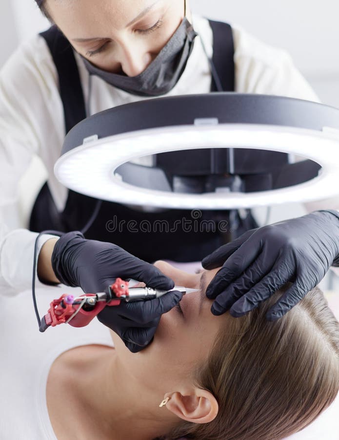 Microblading Eyebrows Work Flow in a Beauty Salon. Woman Having Her Eye ...