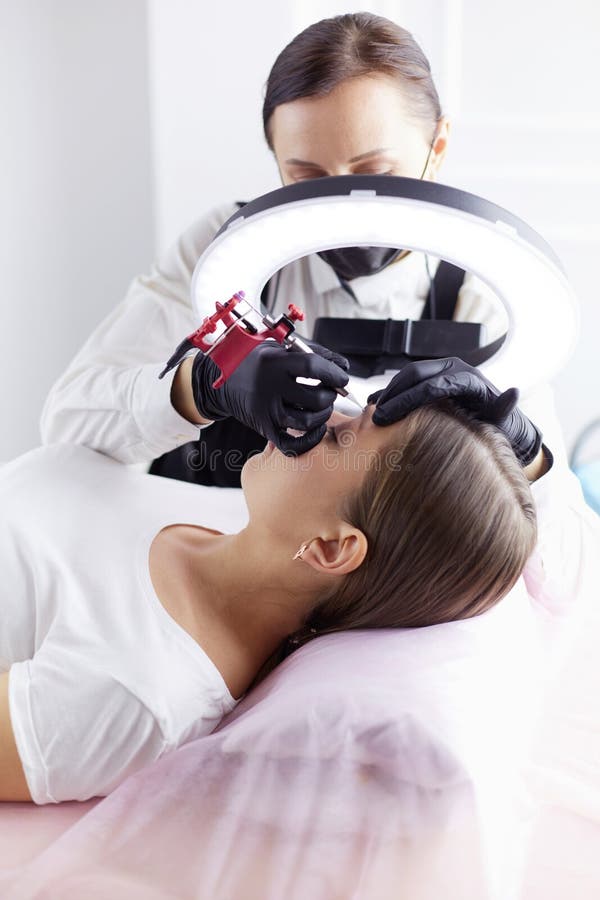 Microblading Eyebrows Work Flow in a Beauty Salon. Woman Having Her Eye ...