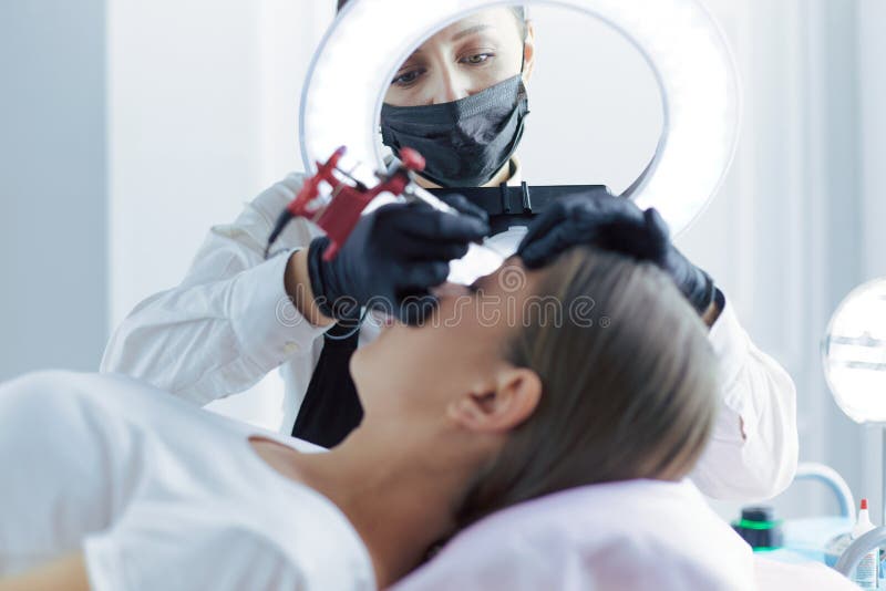 Microblading Eyebrows Work Flow in a Beauty Salon. Woman Having Her Eye ...