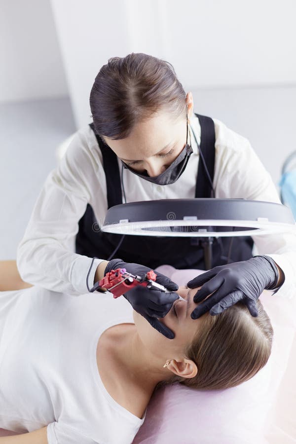 Microblading Eyebrows Work Flow in a Beauty Salon. Woman Having Her Eye ...