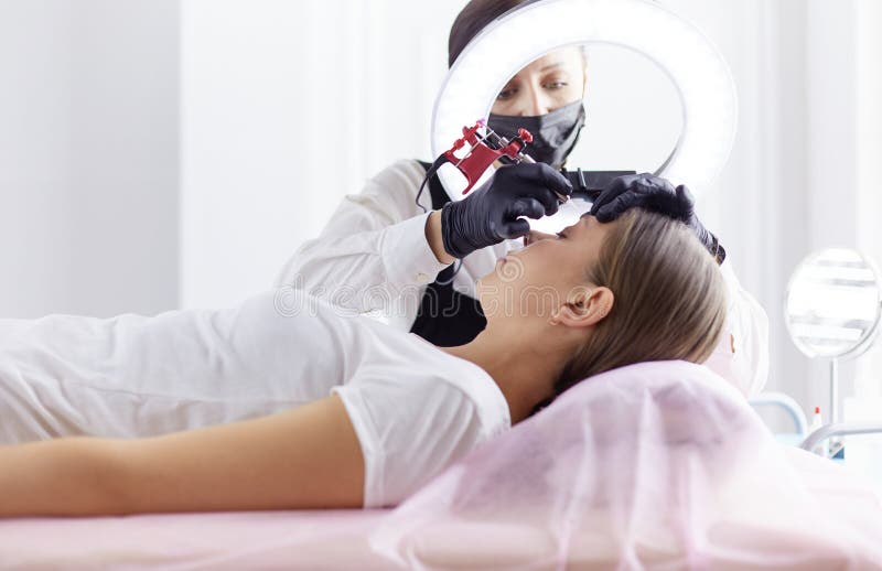 Microblading Eyebrows Work Flow in a Beauty Salon. Woman Having Her Eye ...