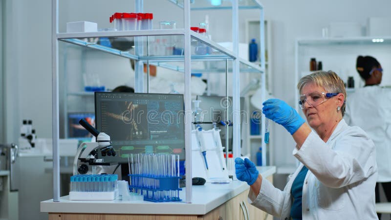 Microchemist Doing Research Checking Liquid in Test Tube at Laboratory ...