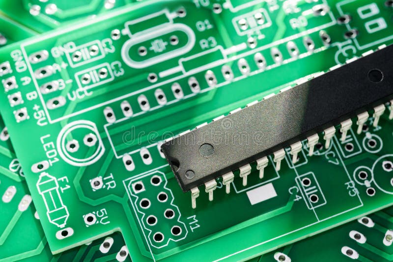 Microchip on a Green Printed Circuit Board with Various Soldering ...