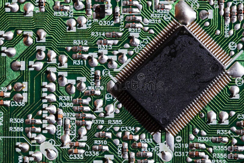 A Microchip Soldered on an Intricate Green Electronic Circuit Board ...