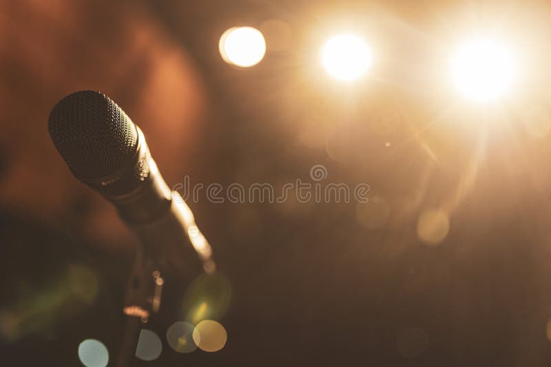 Microphone Awaiting Performer on Stage Under Warm Lights Stock Photo ...
