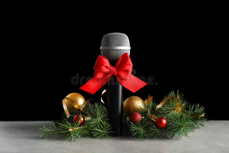 Microphone with Red Bow and Fir Branches Against Blurred Lightst ...