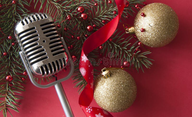Microphone with Red Bow and Fir Branches Against Blurred Lightst ...