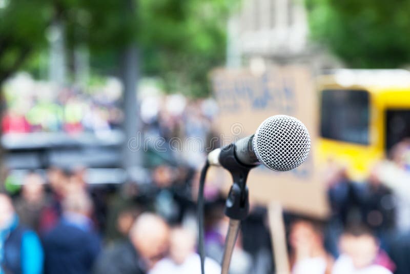 Microphone in Focus Against Blurred Protest or Public Demonstration ...