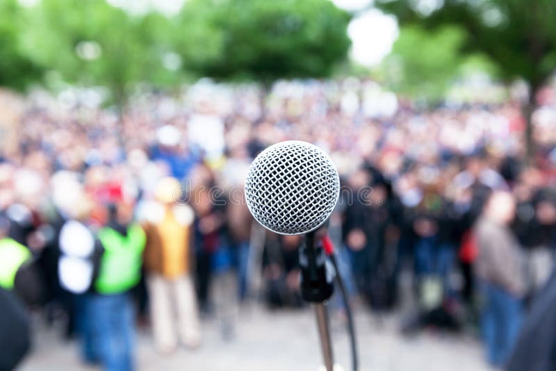 Microphone in Focus Against Blurred Protest or Public Demonstration ...