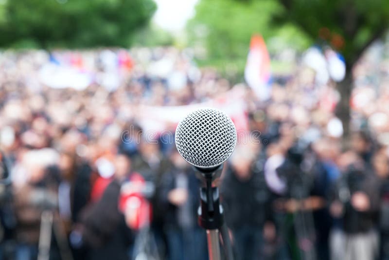 Microphone in Focus Against Blurred Protest or Public Demonstration ...