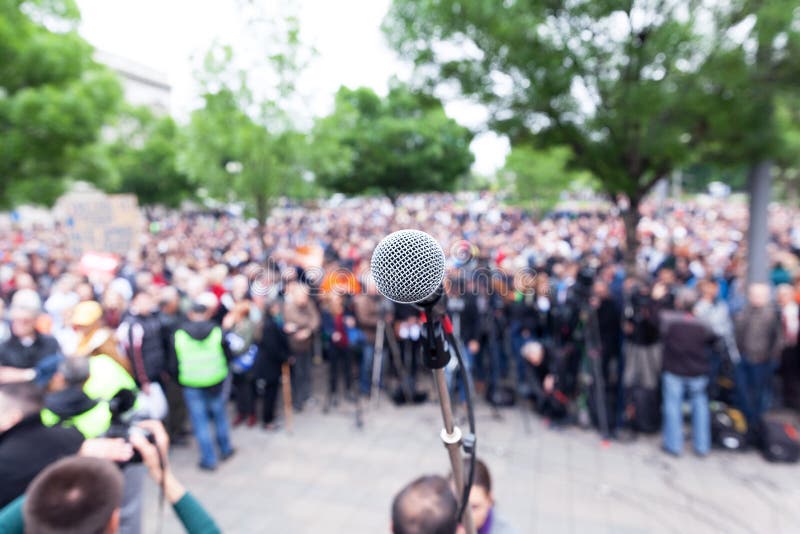 Microphone in Focus Against Blurred Protest or Public Demonstration ...