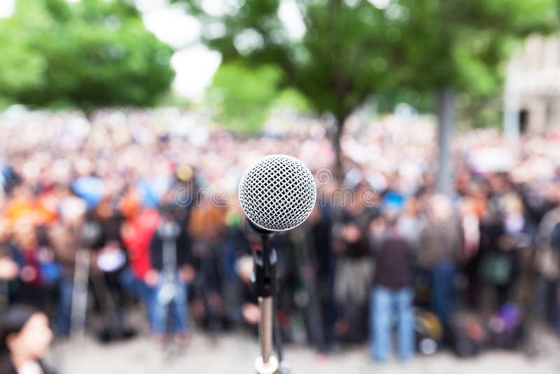 Microphone in Focus Against Blurred Protest or Public Demonstration ...