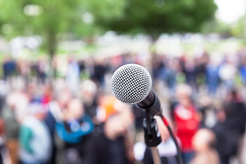 Microphone In Focus Against Blurred Crowd. Filming Street Protest ...
