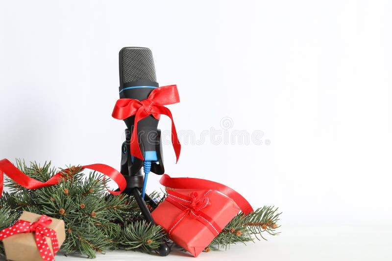 Microphone with Red Bow and Fir Branches Against Blurred Lightst ...