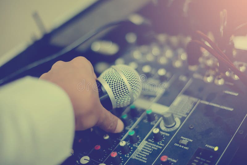 Microphone in Hand and Adjust an Audio Mixer Controller in the C Stock ...