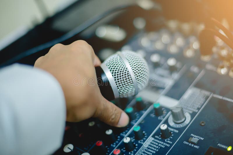 Microphone in Hand and Adjust an Audio Mixer Controller in the C Stock ...