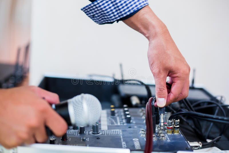 Microphone in Hand and Plugin Audio Jack To Mixer Controller in the ...