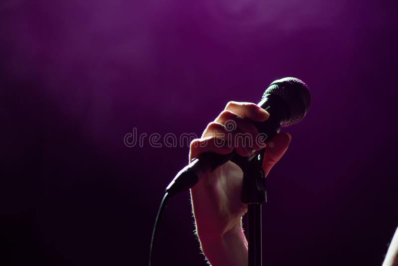 Microphone in Hand Singer on Stage. Live Music Background. Microphone ...