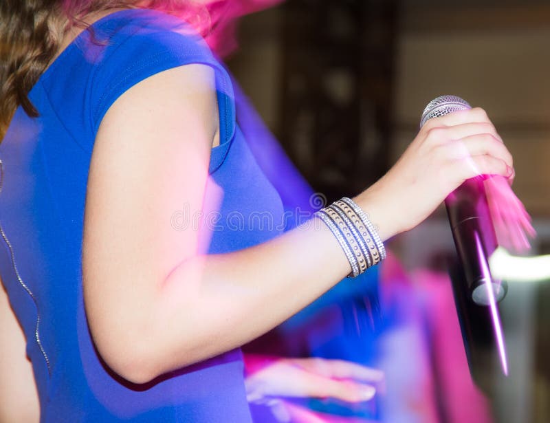 Microphone in the Hands of the Girl on Stage Stock Image - Image of ...