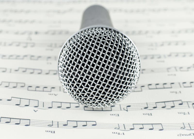 Microphone on Musical Notes Paper Stock Photo - Image of party, audio ...
